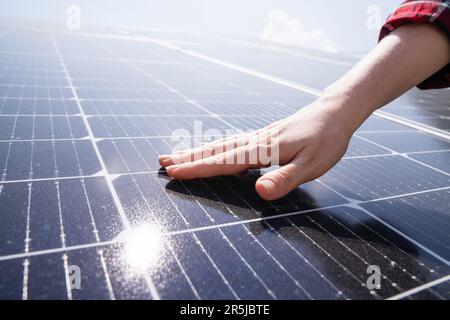 Close-up of a hand touching a solar panel Stock Photo - Alamy
