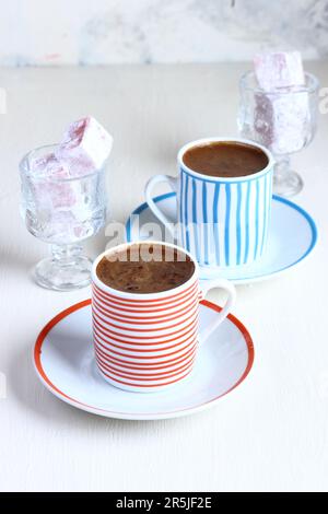 Traditional Turkish coffee and Turkish delight on a painted dark blue ...