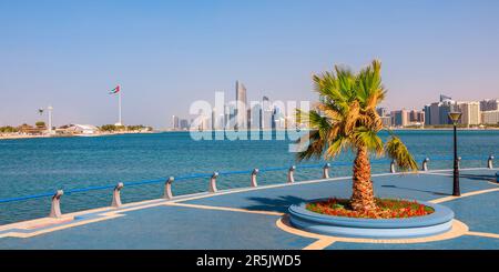 Abu Dhabi with palm trees and skyscrapers. Sunny summer in UAE Stock ...