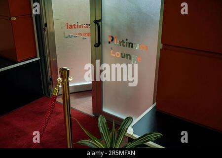 Opened glass door leading to modern dining room with glass fireplace in ...