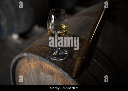 Whisky barrels ready to sample with copper spirit thief at the ...
