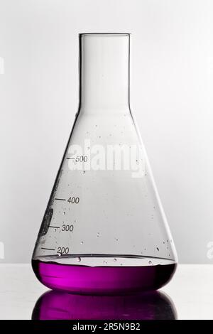 Empty chemical jar filled with violet liquid Stock Photo - Alamy