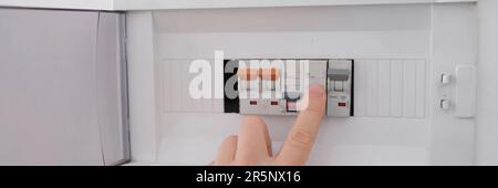 Turning on circuit breaker on control panel after it tripped due to ...