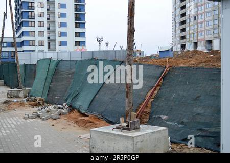 A mess at a construction site with scattered building materials and ...