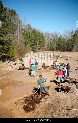 Farmers Digging in the mud to create Rice Paddies Stock Photo - Alamy