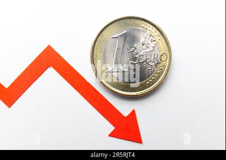 1 Euro coin, next to descending line. Valuation of the Euro and falling ...
