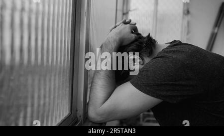 Man struggling with depression at home. Dramatic monochromatic black ...