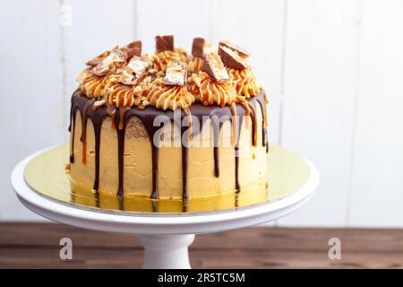 Gorgeous snickers cake with peanut butter cream, melted chocolate ...