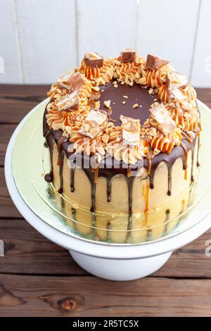 Gorgeous snickers cake with peanut butter cream, melted chocolate ...