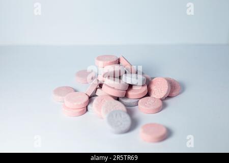pink and blue multivitamin tablets on a white background Stock Photo ...