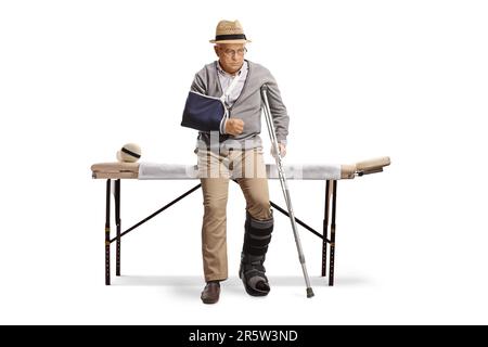 Elderly man with a leg brace sitting on a bed and a female doctor ...