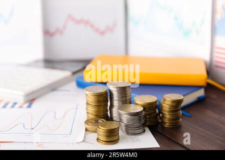 Stacks of coins on table and diagrams on virtual screen. Exchange rate ...