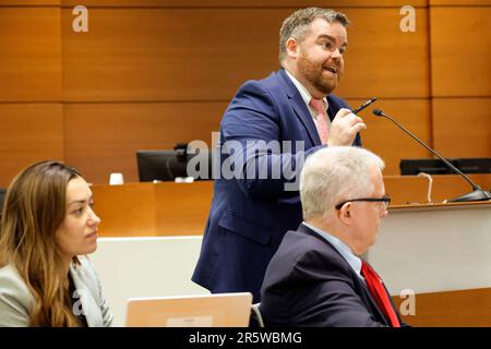 Assistant State Attorney Christopher Killoran looks at papers during ...