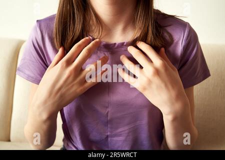 Teenage girl tapping on the collarbone point - practicing EFT or ...