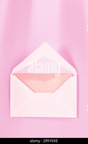 an opened pink envelope with card Stock Photo - Alamy