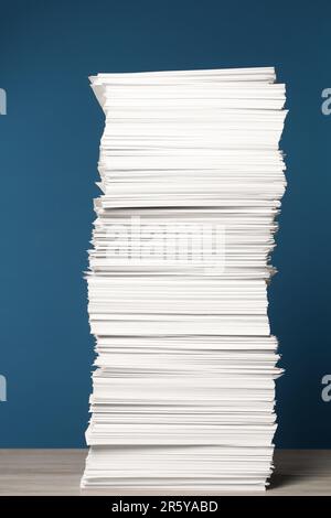 A stack of clean blue sheets of paper on a white background, top view ...