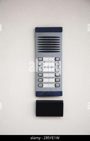Modern intercom on beige wall near door outdoors, space for text Stock ...