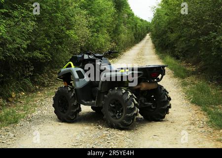 Beautiful quad bike on pathway near trees outdoors Stock Photo - Alamy