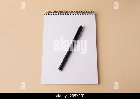 Notepad with erasable pen on beige background, top view Stock Photo - Alamy