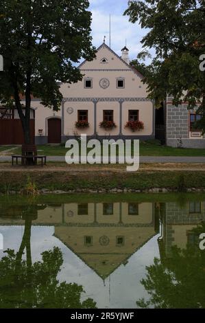 Window boxes and pointed gable of farmstead in Holašovice, South ...