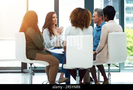 Success has to be planned for. a group of colleagues having a meeting ...