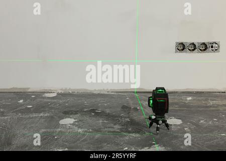Laser level on floor near electrical sockets Stock Photo - Alamy