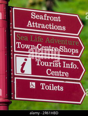 Signpost showing directions to local attractions, downtown city ...