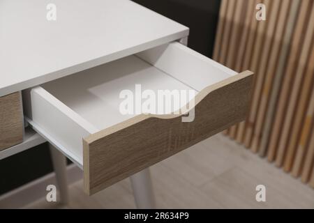 Stylish desk with open empty drawer in office Stock Photo - Alamy