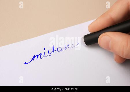 Child erasing word Mistake written with erasable pen on sticky note ...