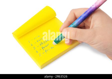 Child erasing word Five written with erasable pen on sticky note ...