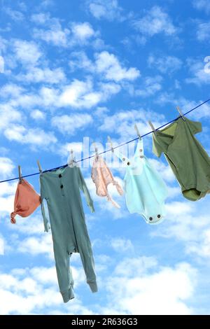 Different baby clothes drying on washing line outdoors Stock Photo - Alamy