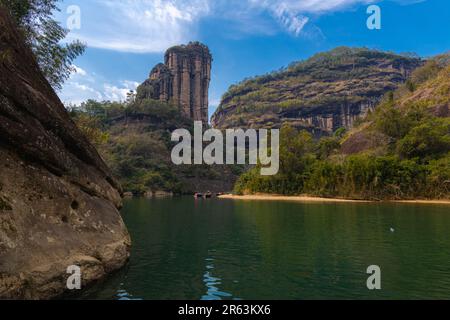 A rock cliff lining the nine bend river or Jiuxi in Wuyishan or Mount ...