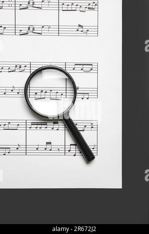 Magnifier with music sheet on black and white background Stock Photo ...