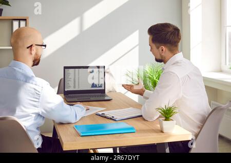 employees discussing financial charts Stock Photo - Alamy