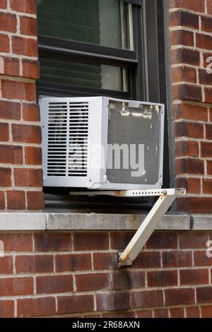 Vertical shot of an air conditioning unit sitting on the patio of a ...