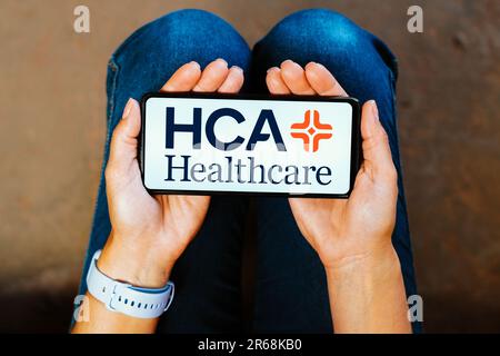 In this photo illustration, a HCA Healthcare logo is seen displayed on ...