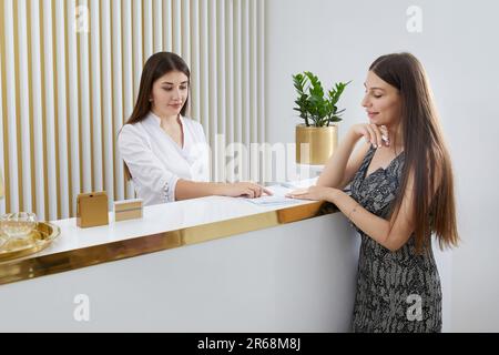 Welcome sign and desk at a modern reception area, London, England, UK ...