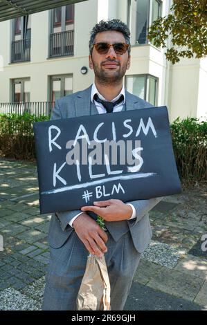 A protester holds a placard during the Sanda Dia protest outside the ...