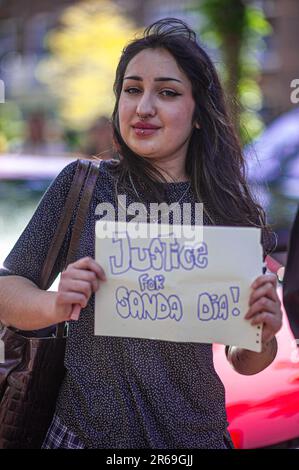 A protester holds a placard during the Sanda Dia protest outside the ...
