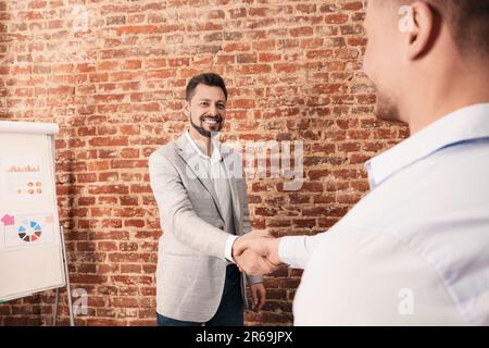 Office employees shaking hands during meeting at work Stock Photo - Alamy