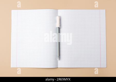 Copybook with erasable pen on beige background Stock Photo - Alamy