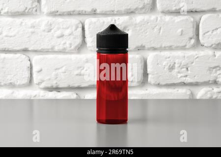 Refill liquid for electronic cigarettes against brick wall background ...