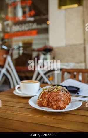 Breakfast time with croissant, coffee, and magazine Stock Photo - Alamy
