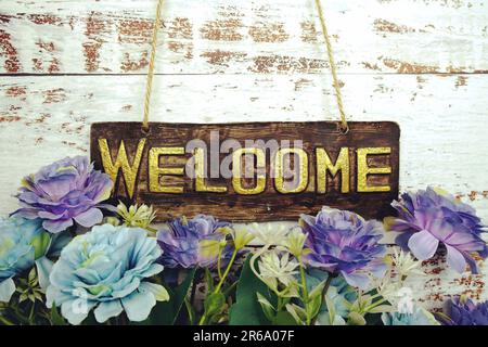 Welcome Sign with flowers frame decorate on wooden background Stock ...