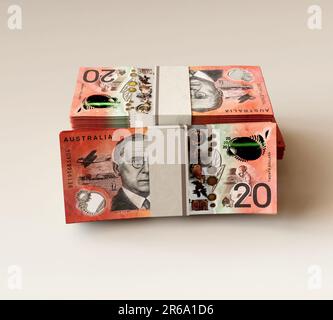 A stack of bundled australia dollar banknotes on an isolated light ...