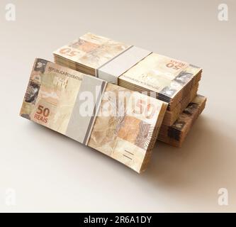 A stack of bundled brazilian real banknotes on an isolated light ...