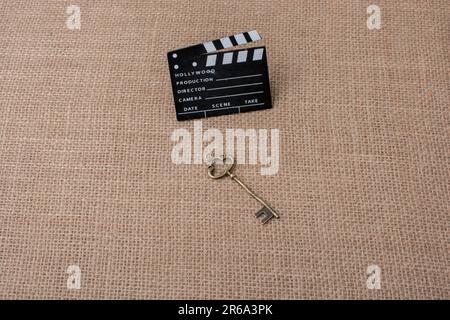 Movie clapper and retro key on canvas background Stock Photo - Alamy