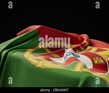A portugal flag draped over a stone plinth on an isolated dark studio ...