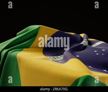 A brazil flag draped over a stone plinth on an isolated dark studio ...