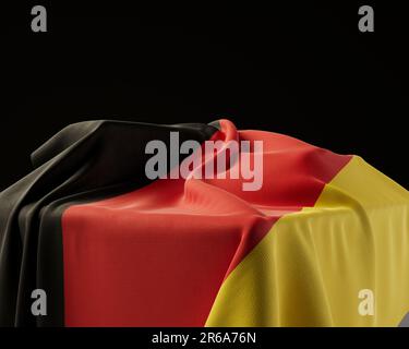 A germany flag draped over a stone plinth on an isolated dark studio ...